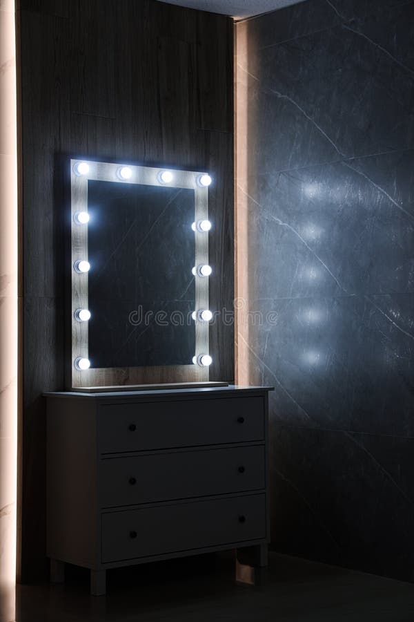 Modern Mirror with Light Bulbs on Grey Chest of Drawers in Room Stock ...