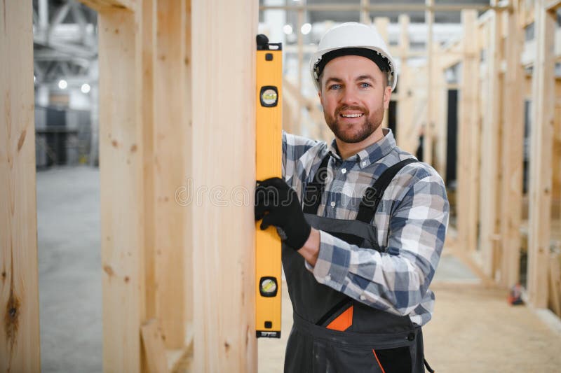 Modern Modular House. a Worker Works on the Construction of a Wooden ...