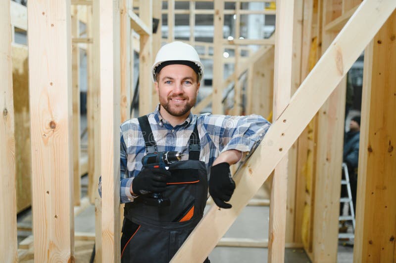 Modern Modular House. a Worker Works on the Construction of a Wooden ...