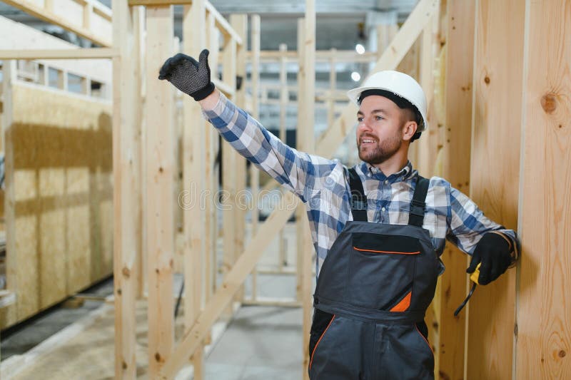 Modern Modular House. a Worker Works on the Construction of a Wooden ...