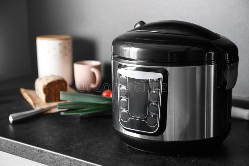 Modern Multi Cooker and Ingredients on Table in Kitchen Stock Image ...