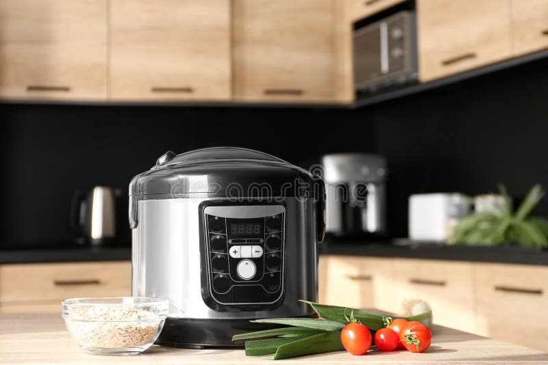 Modern Multi Cooker and Ingredients on Table in Kitchen Stock Image ...