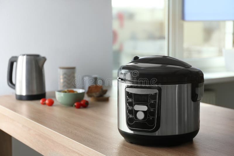 Modern Multi Cooker and Ingredients on Table in Kitchen Stock Image ...