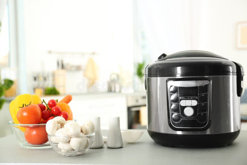 Modern Multi Cooker and Products on White Table in Kitchen. Stock Photo ...