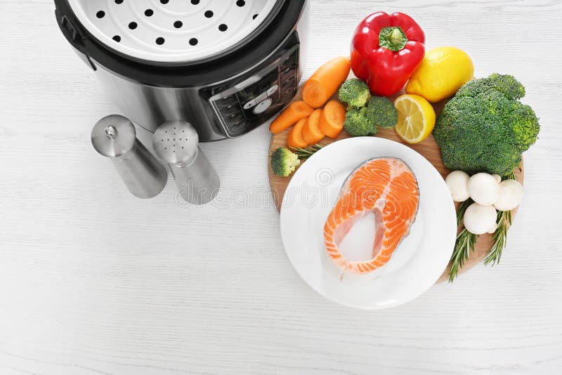 Modern Multi Cooker and Products on White Wooden Table Stock Image ...