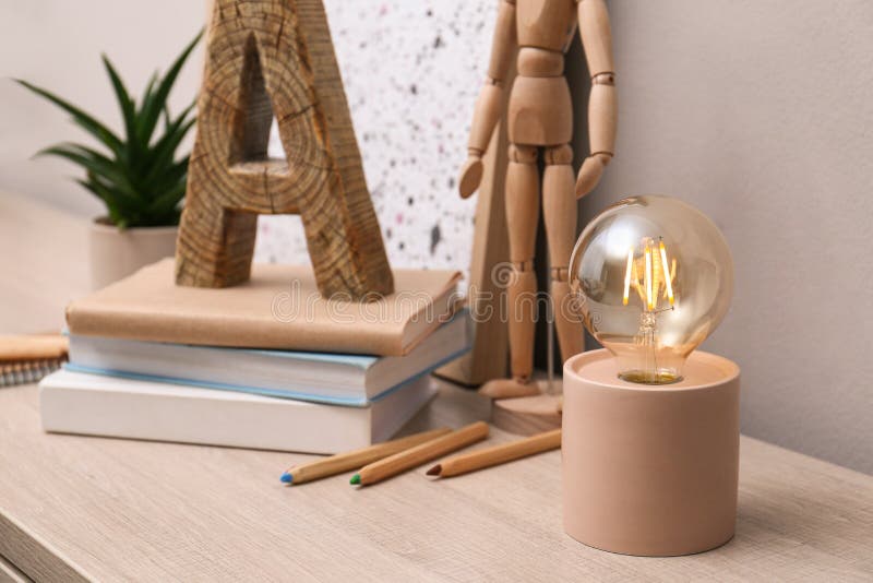 Modern Night Lamp, Books and Decor on Table Indoors. Space for Text ...