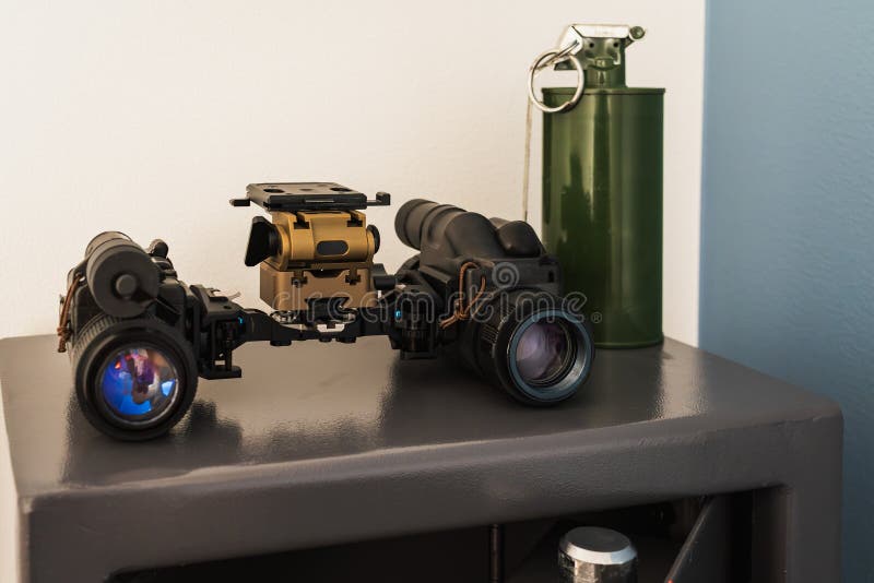 Modern Night Vision Goggles and a Grenade are Placed on a Surface ...