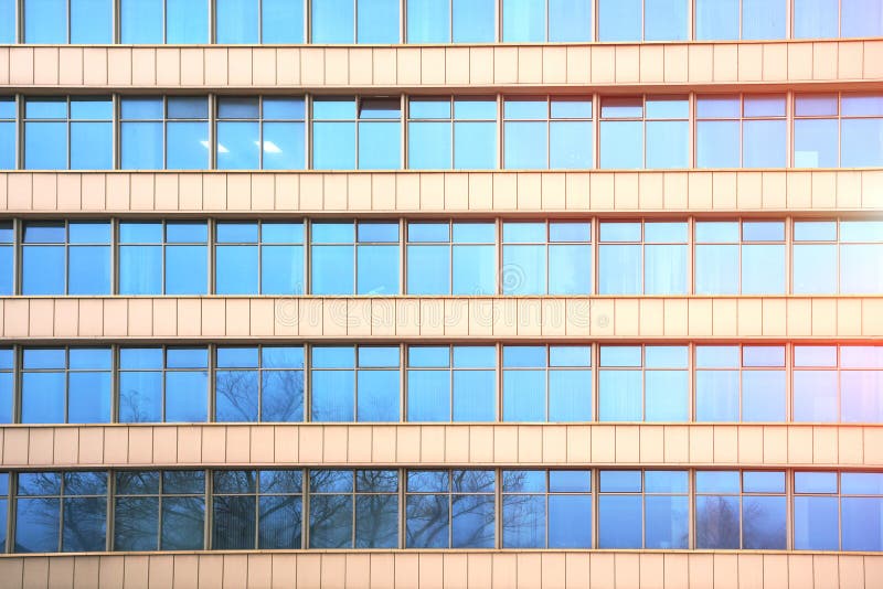 Modern Office Building Facade with Rows of Windows Reflecting Blue Sky ...