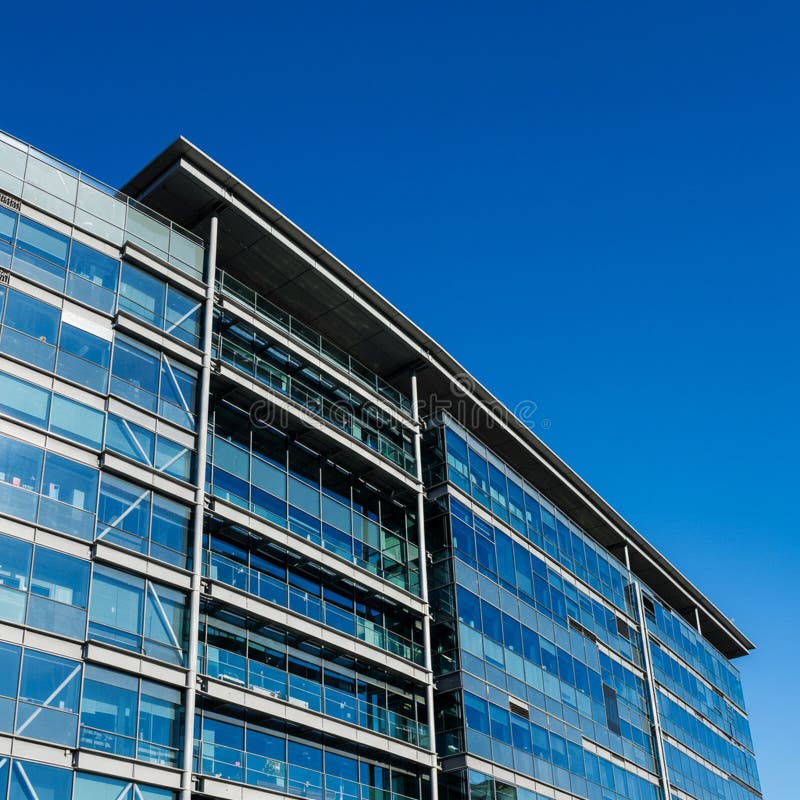 A Modern Office Building Featuring a Curved Facade with Extensive Glass ...