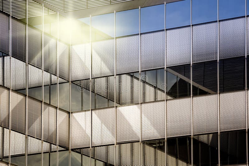 A Modern Office Building with Sun Blinds Down and a Reflective Facade ...