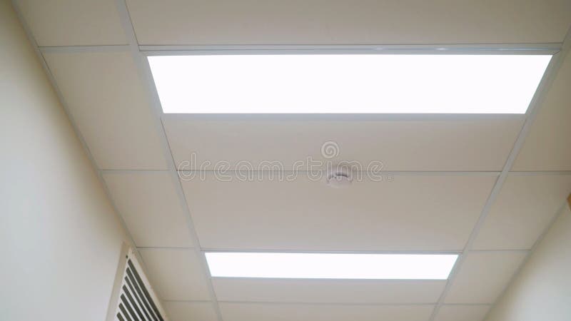 Modern Office Ceiling Featuring Led Panel Lights and Smoke Detector ...