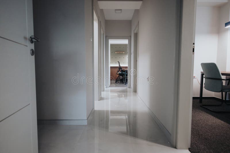 Modern Office Hallway Leading To a Stylish Workspace with Open Doors ...