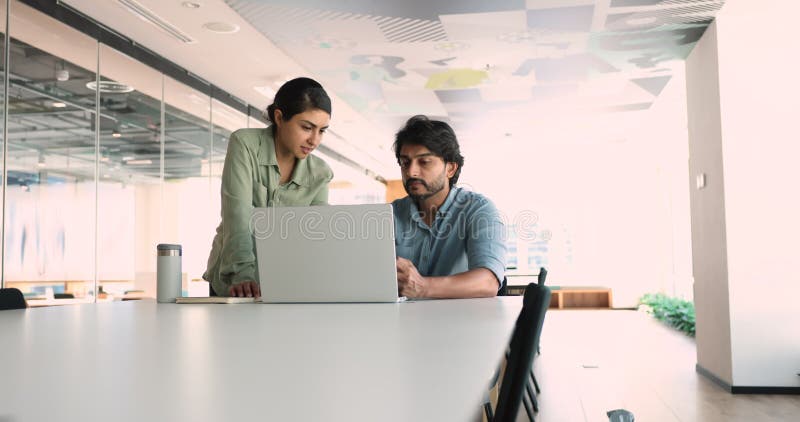 In Modern Office, Indian Colleagues Collaborate, Working Using Laptop ...