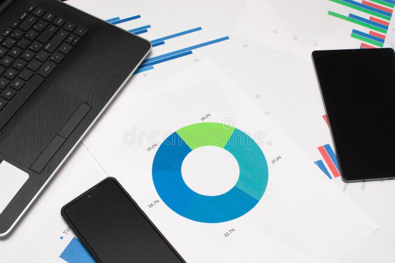Modern Office Setting Featuring a Cell Phone, Tablet, Pie Chart and ...