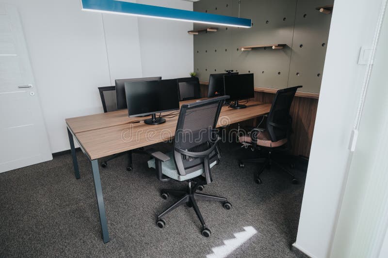 Modern Office Space with Ergonomic Chairs and Sleek Desktop Setups ...