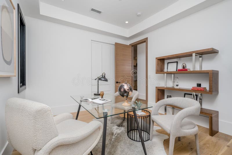 Modern Office Space Features a Large Glass Desk in the Center ...