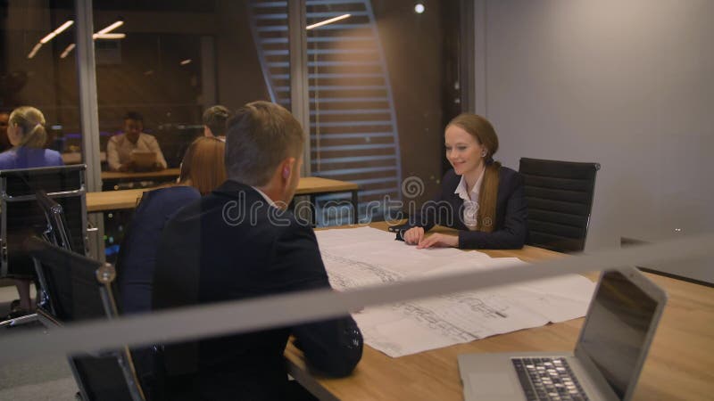 In the Modern Office Three Staff at the Table Look the Drawing Paper ...