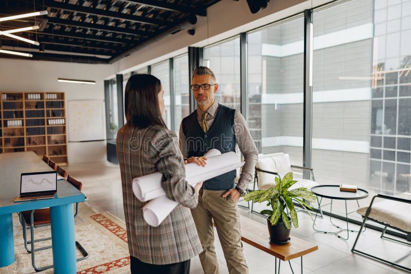 Professionals Engaged in Dynamic Discussion about Project Plans in a ...