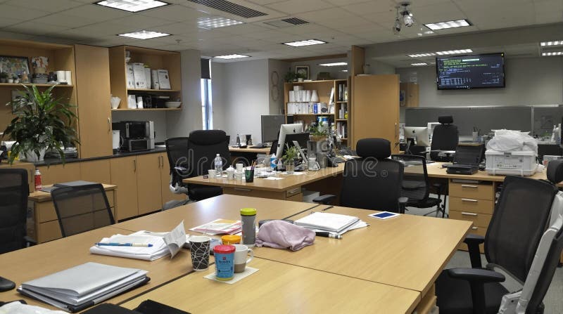 A Modern Office Workspace Featuring Organized Desks, Vibrant Plants ...