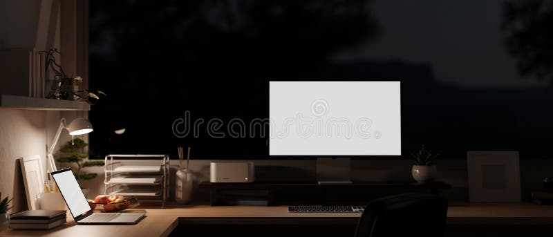 Modern Office Workspace at Night with a Computer and Laptop on a Table ...