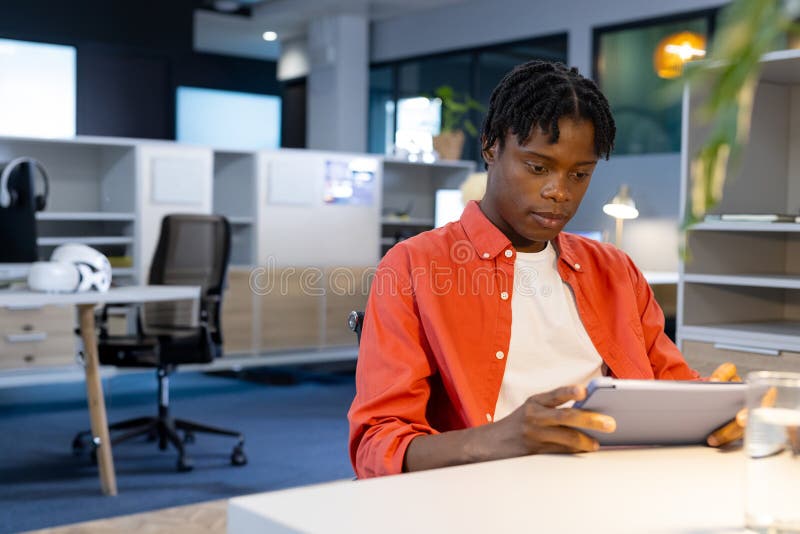 In Modern Office, Young Man Using Tablet, Concentrating on Digital Work ...