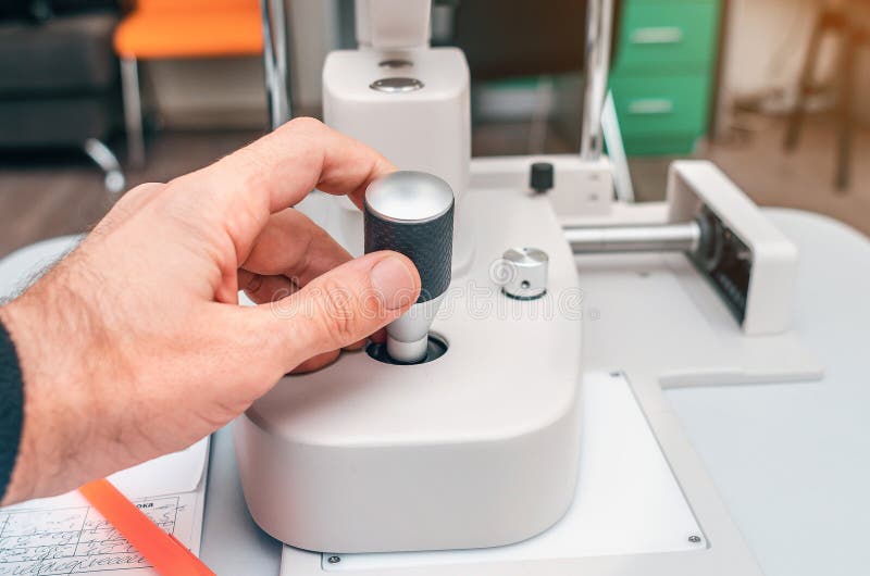 Modern Ophthalmological Device. a Man S Hand Holds the Handle of the ...