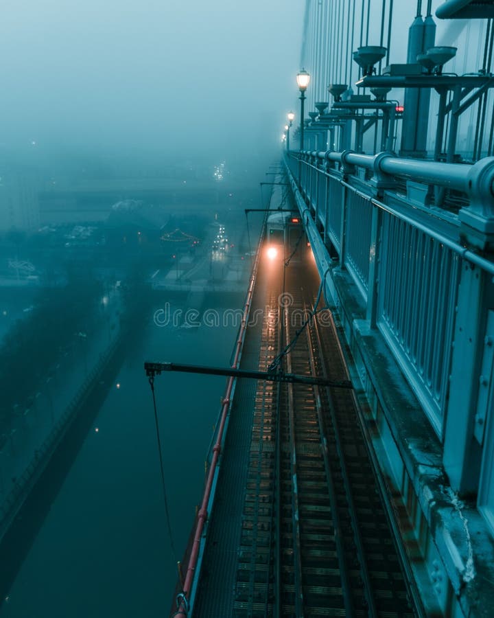 Modern Passenger Train Traveling Along a Bridge Illuminated by the ...