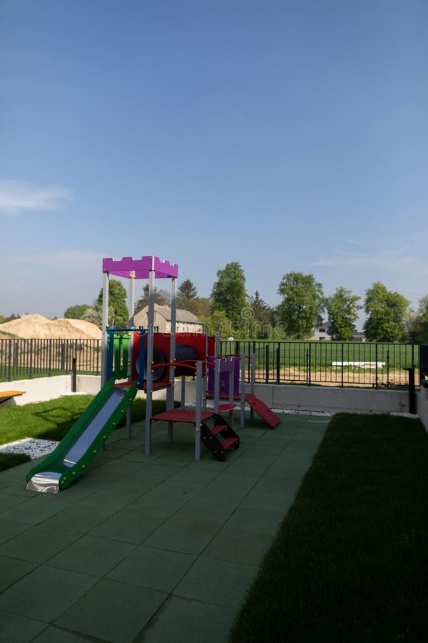 A Modern Playground Featuring a Colorful Slide and an Engaging Climbing ...