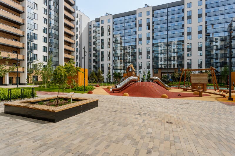 Modern Playground with Slides and Swings in the Courtyard of a New ...