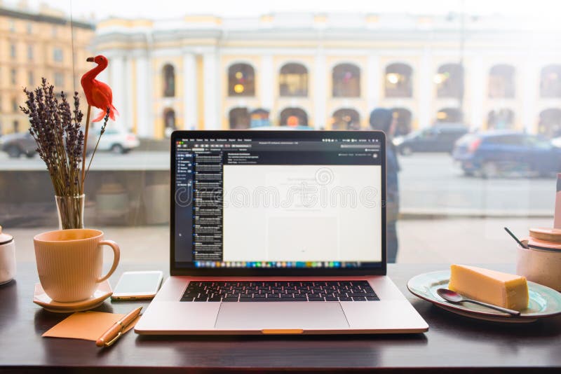Modern Portable Notebook on Table in Restaurant Near Plate with Cake ...