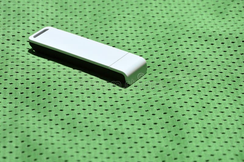 A Modern Portable USB Wi-fi Adapter is Placed on the Green Sportswear ... A Modern Portable USB Wi-fi Adapter is Placed on the Green Sportswear ...