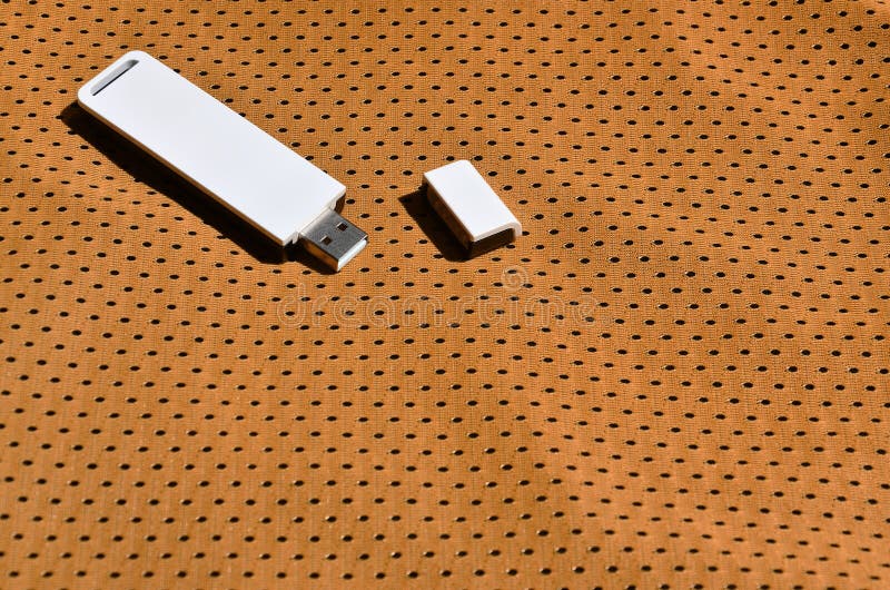A Modern Portable USB Wi-fi Adapter is Placed on the Orange Sportswear ... A Modern Portable USB Wi-fi Adapter is Placed on the Orange Sportswear ...