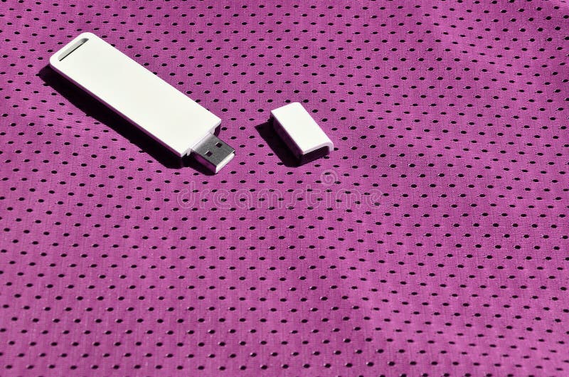 A Modern Portable USB Wi-fi Adapter is Placed on the Purple Sportswear ... A Modern Portable USB Wi-fi Adapter is Placed on the Purple Sportswear ...