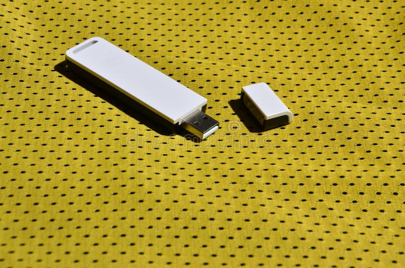 A Modern Portable USB Wi-fi Adapter is Placed on the Yellow Sportswear ... A Modern Portable USB Wi-fi Adapter is Placed on the Yellow Sportswear ...
