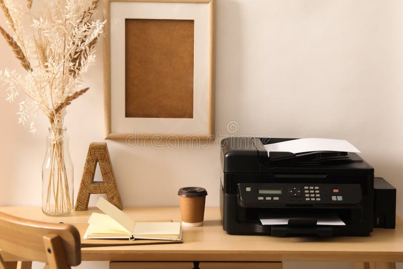 Modern Printer with Paper, Notebook and Cup of Drink on Wooden Table ...