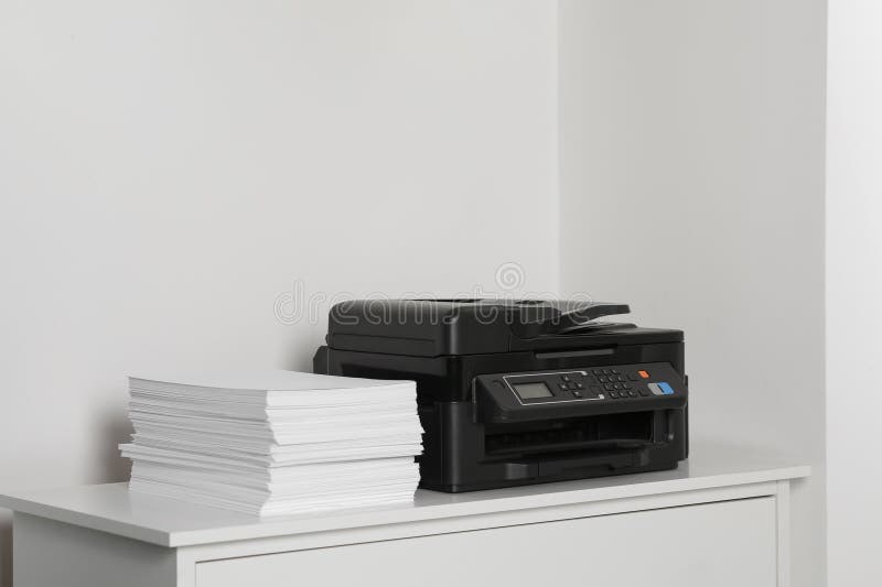Modern Printer and Paper Sheets on White Chest of Drawers Stock Image ...