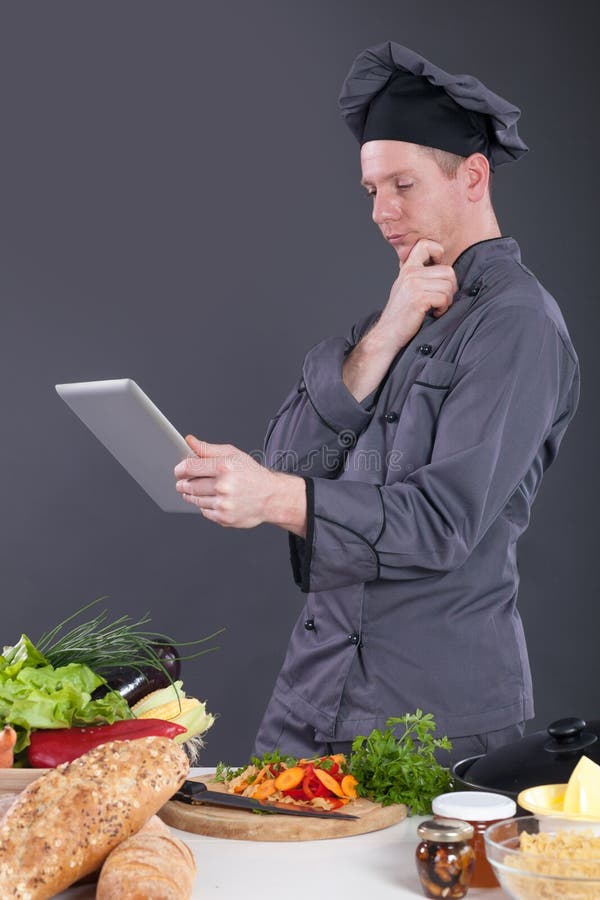 Modern Professional Chef Uses the Tablet for a Selection of Dish Stock ...