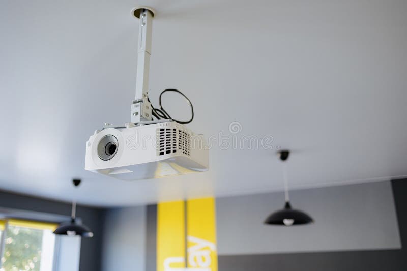 Modern Projector Hanging from Ceiling in a Creative Workspace with ...