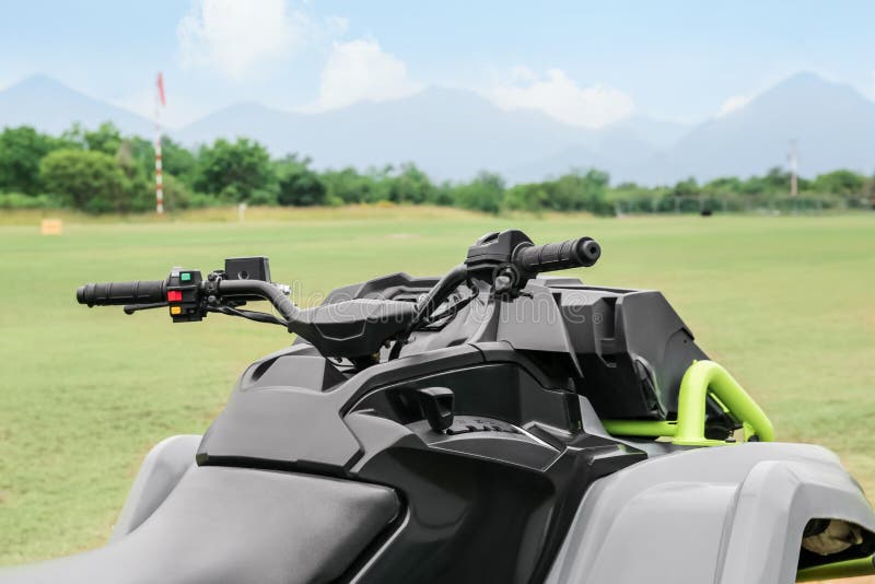 Modern Quad Bike on Green Grass in Field, Closeup Stock Photo - Image ...