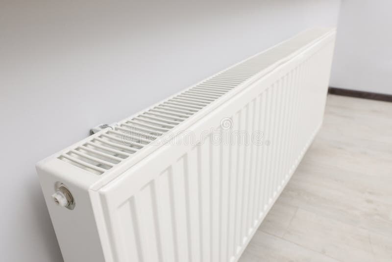 Modern Radiator on White Wall in Room, Closeup. Central Heating System ...