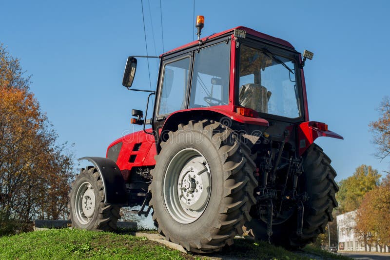 Modern Red Tractor on a Blue Sky Background Stock Image - Image of ...