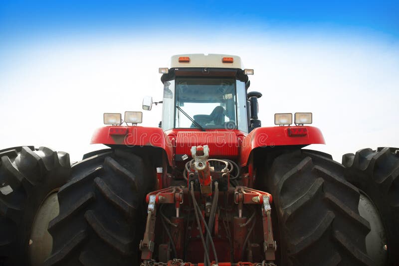 Modern Red Tractor on a Blue Sky Background. Stock Photo - Image of ...