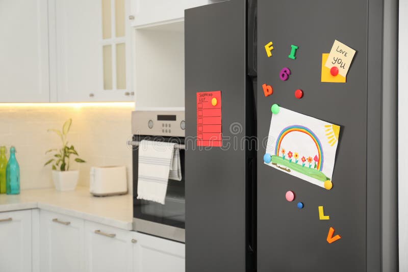 Refrigerator with Child`s Drawing, Notes and Magnets in Kitchen. Space ...