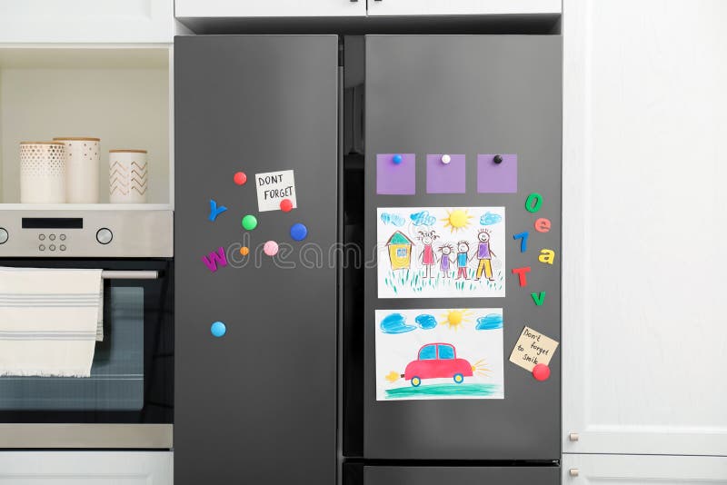 Refrigerator with Child`s Drawings, Notes and Magnets in Kitchen Stock ...