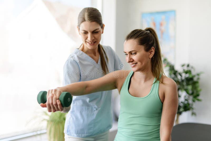 Modern Rehabilitation Physiotherapy Woman Worker with Woman Client ...