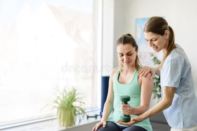 Modern Rehabilitation Physiotherapy Woman Worker with Woman Client ...