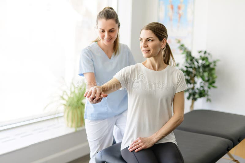 Modern Rehabilitation Physiotherapy Woman Worker with Woman Client ...