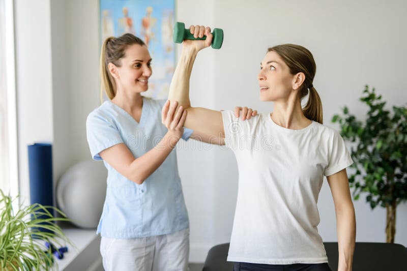 Modern Rehabilitation Physiotherapy Woman Worker with Woman Client ...