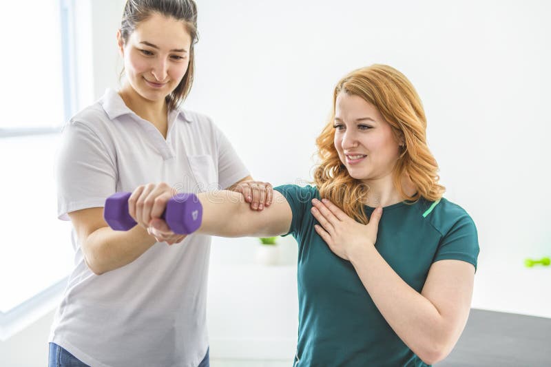 Modern Rehabilitation Physiotherapy at Work with Client Holding ...