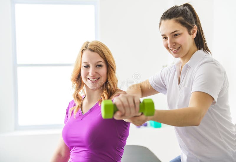 Modern Rehabilitation Physiotherapy at Work with Client Holding Dumbbell Stock Photo - Image of ...